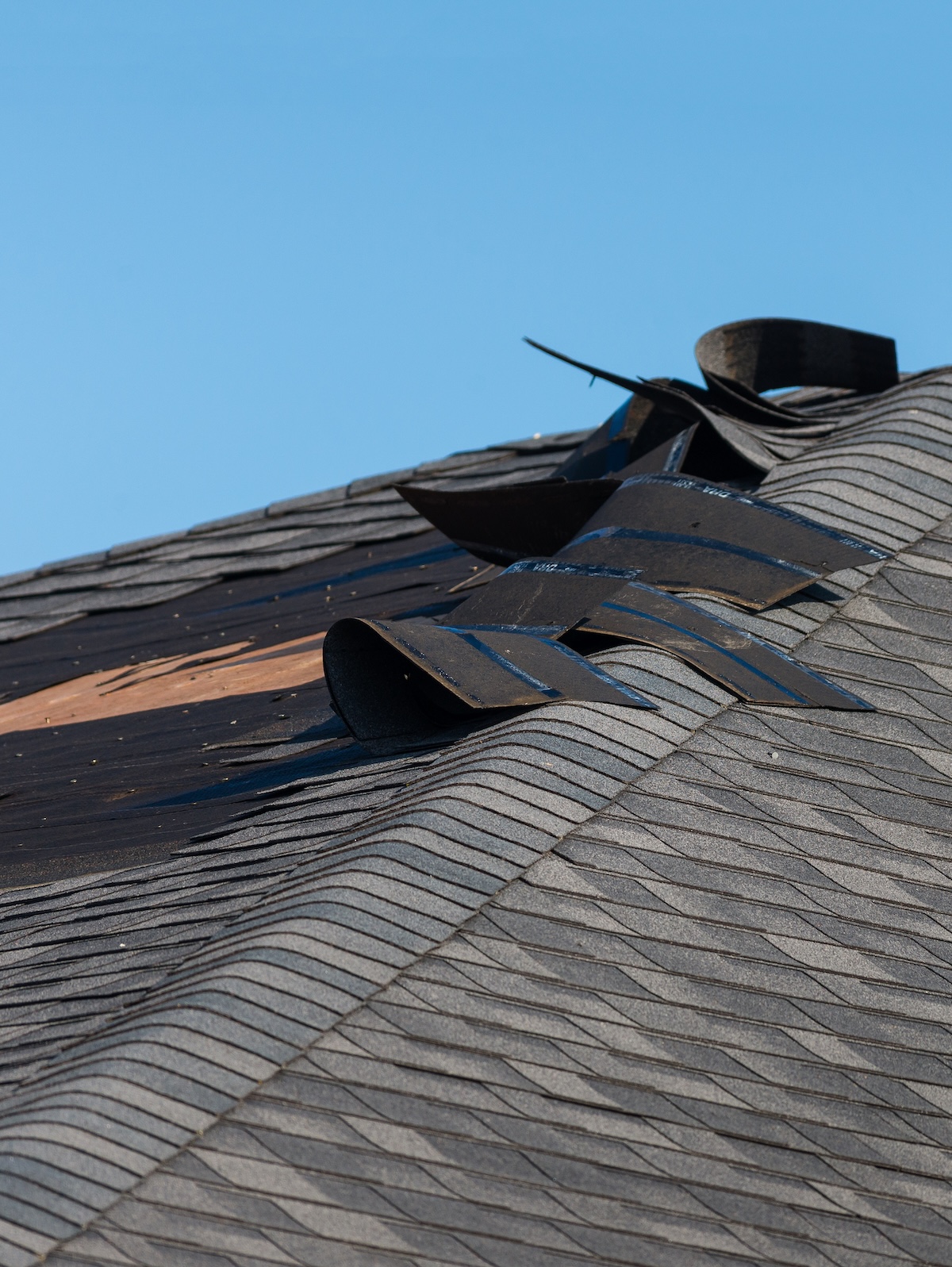 Wind Damage To Roof: 7 Common Signs & What To Do Next